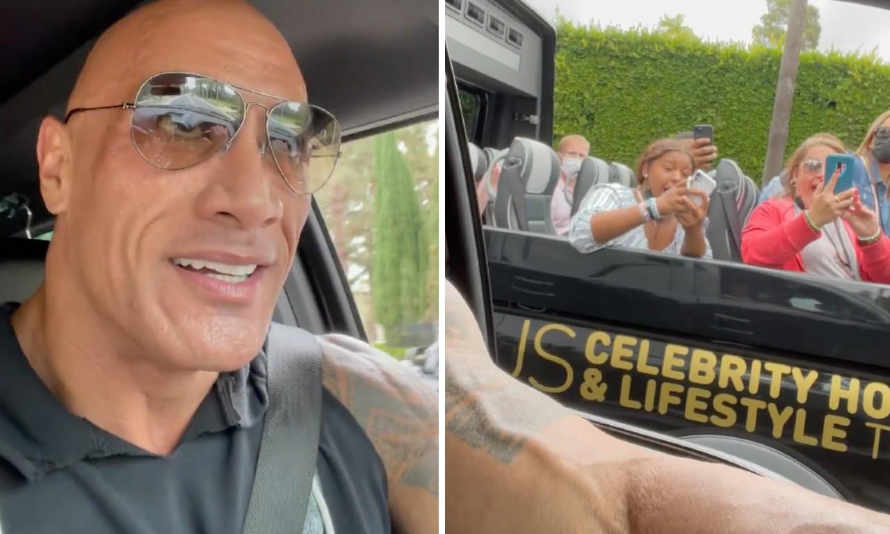 Watch fans go crazy as Dwayne Johnson pulls up beside their tour bus